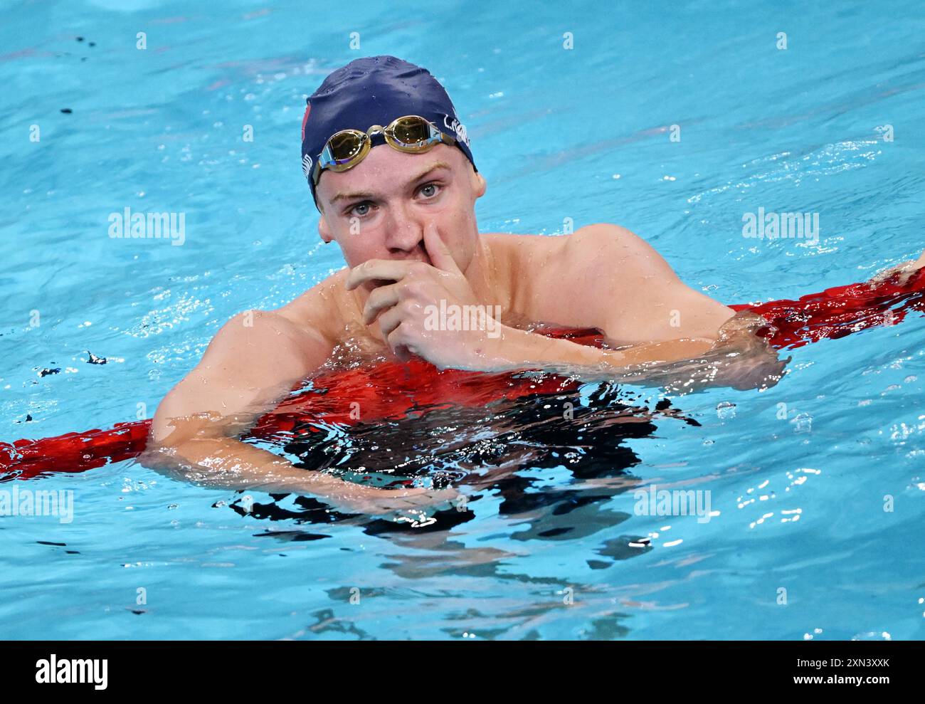 Paris, France. 30th July, 2024. Leon Marchand of France reacts after ...