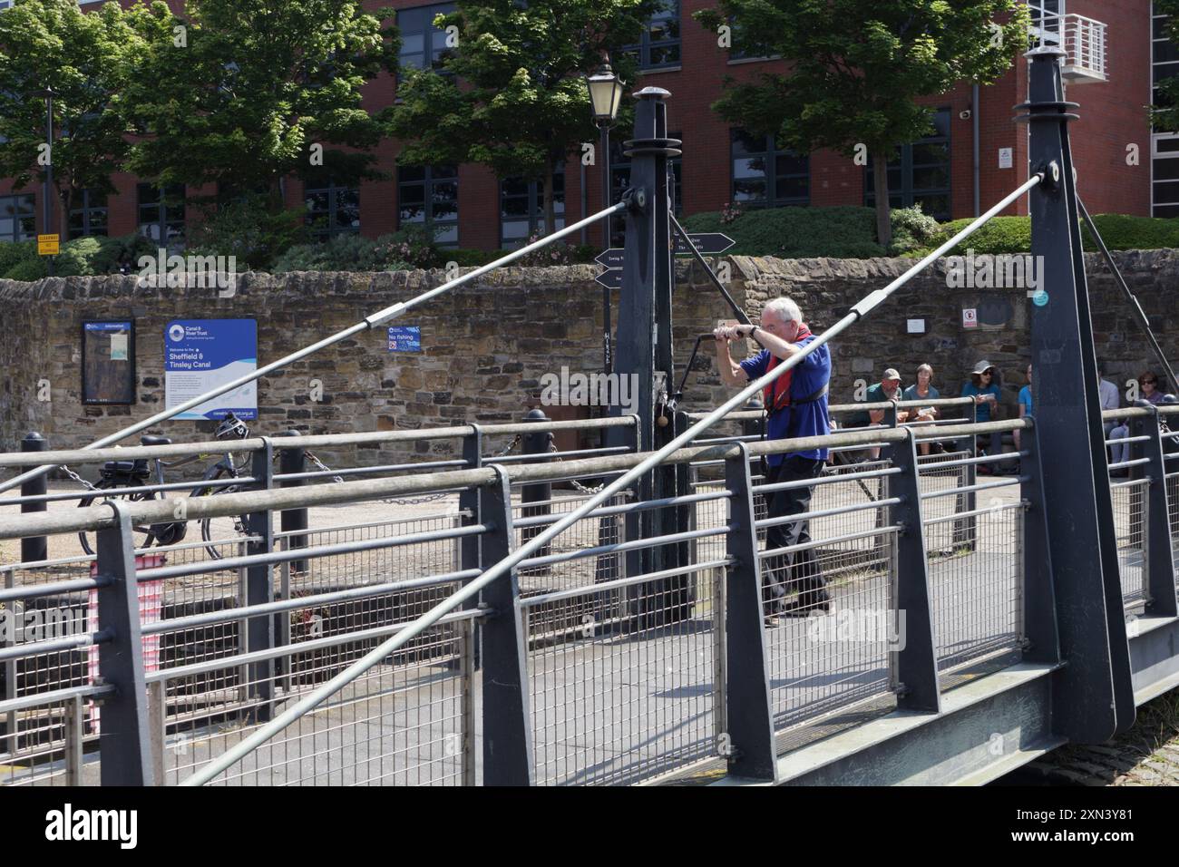 Canal and River Trust worker operating the swing bridge at Victoria ...