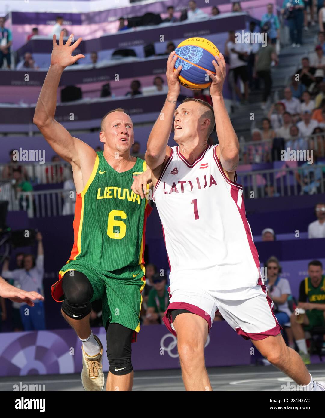 Paris, France. 30th July, 2024. Nauris Miezis (R) of Latvia dribbles during the men's pool round ...