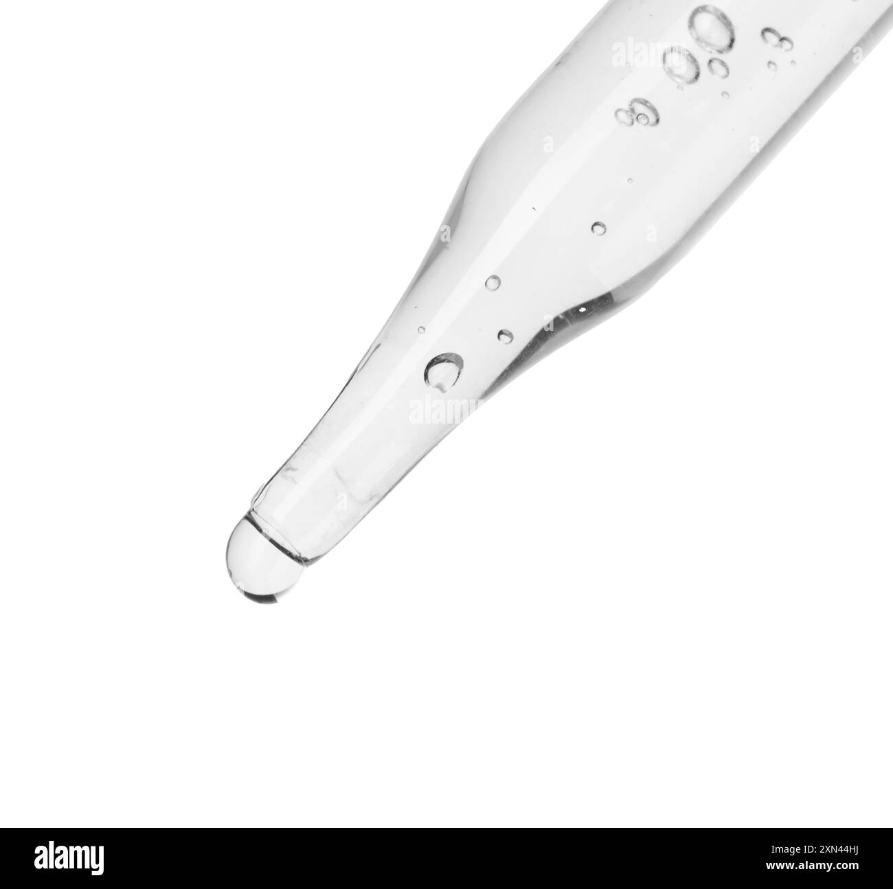 Dripping cosmetic serum from pipette on white background Stock Photo ...