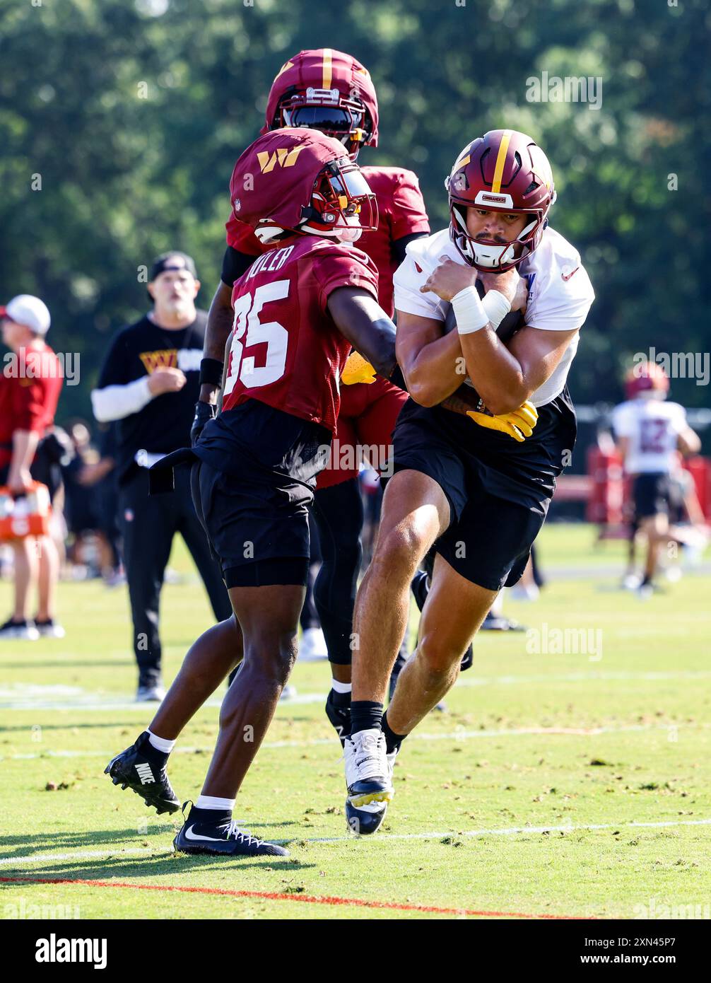 Washington Commanders tight end Cole Turner (85) and safety Percy ...