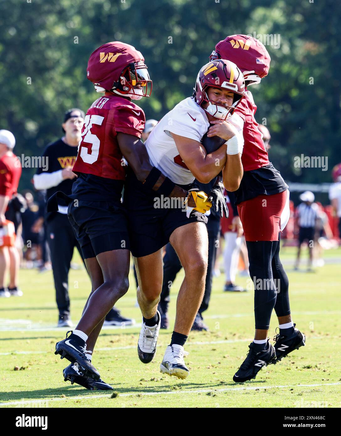 Washington Commanders tight end Cole Turner (85) and safety Percy ...