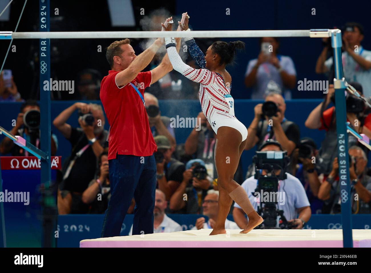 Simone Biles of USA celebrates her exercice at the uneven bars with ...