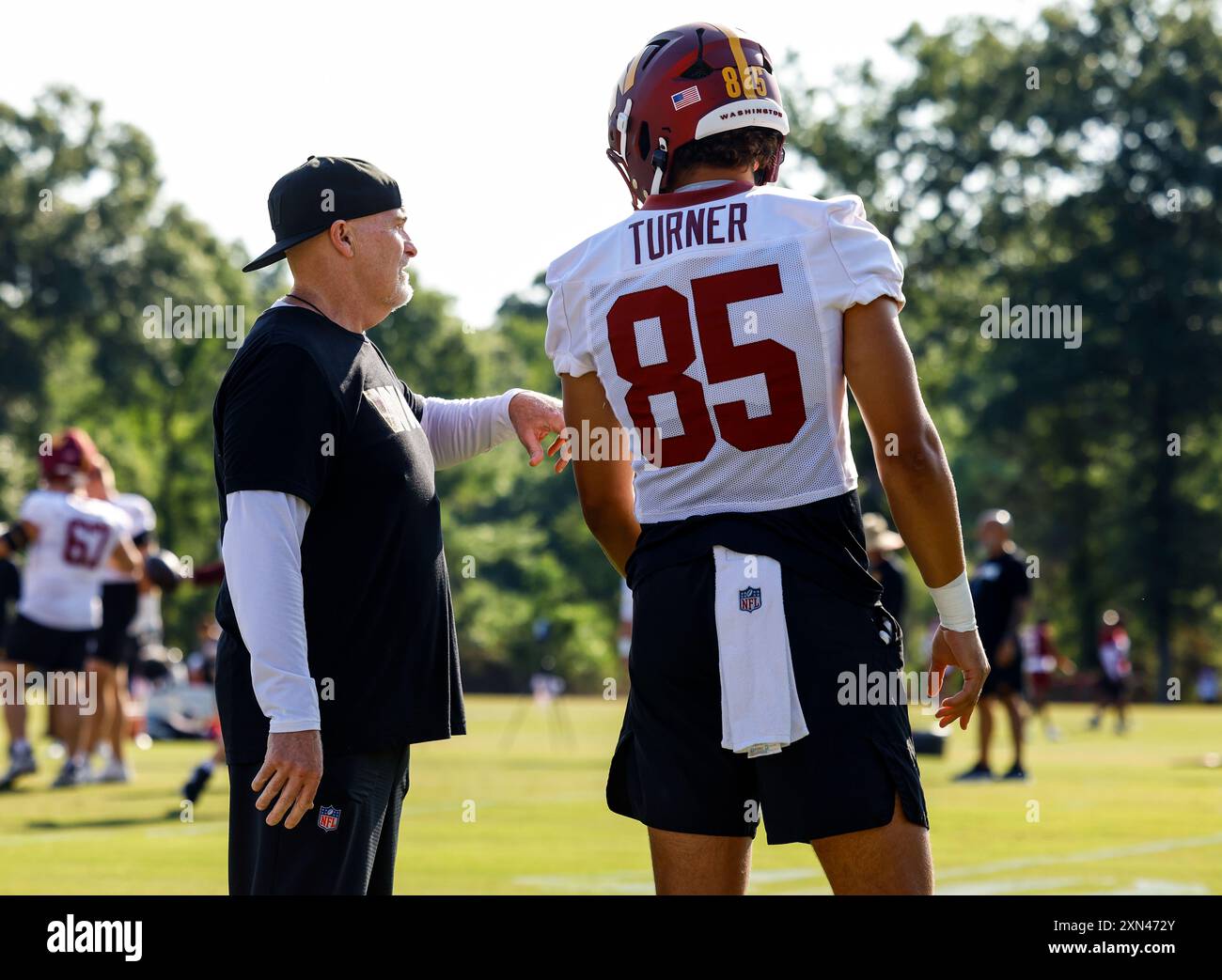 Washington Commanders tight end Cole Turner (85) having a conversation ...