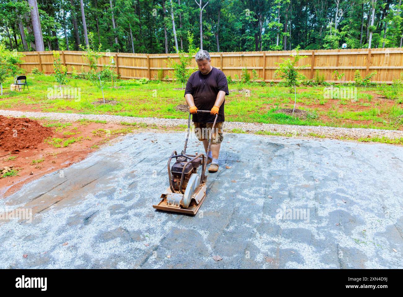 Sand is compacted by vibratory tamping machine during construction of ...
