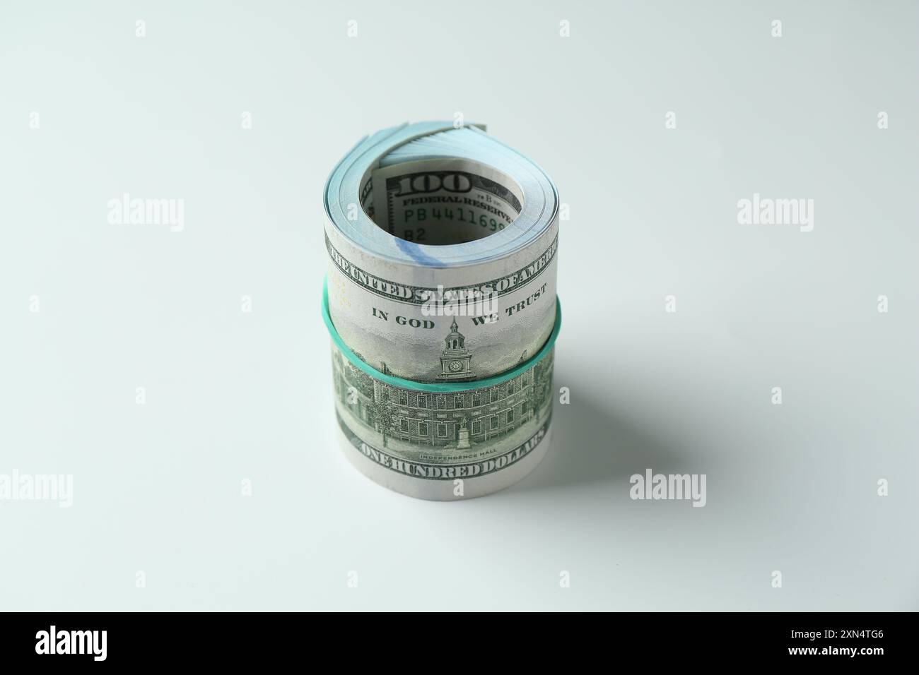 Roll of dollar banknotes on white background Stock Photo - Alamy