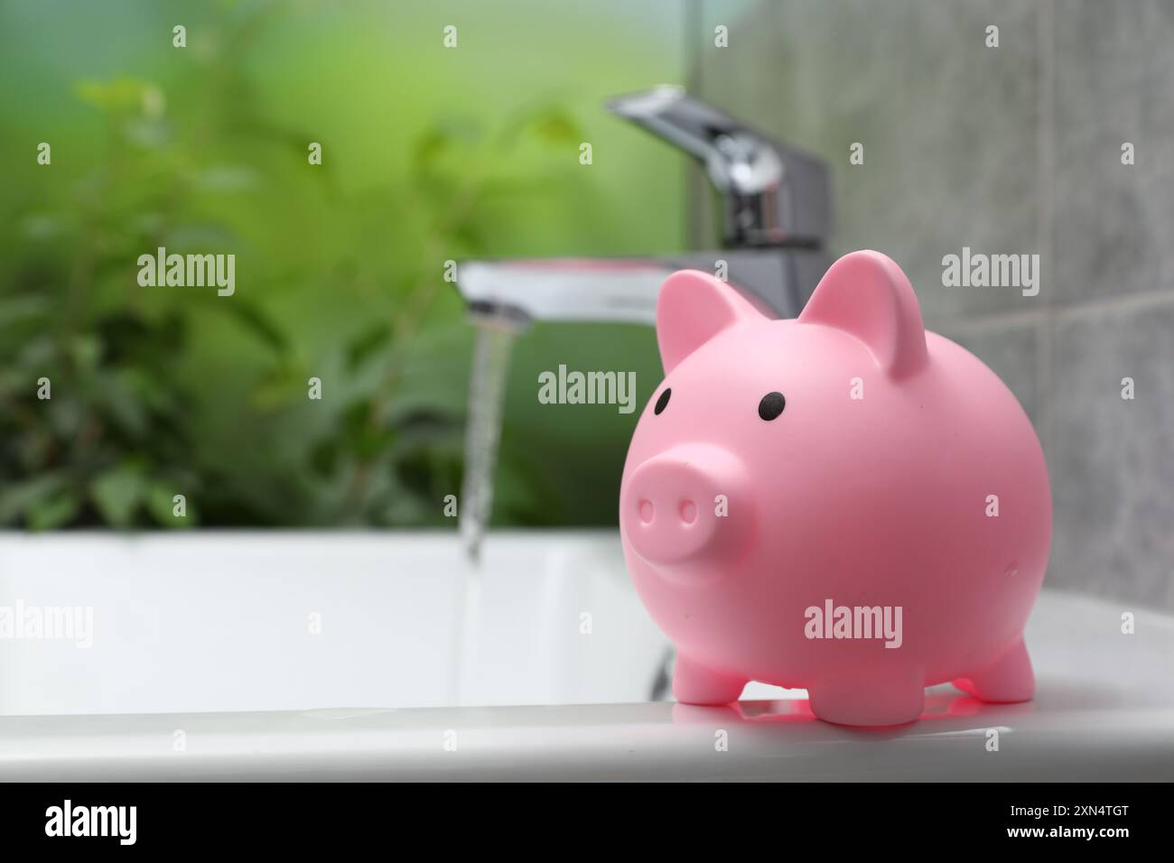 Water saving concept. Piggy bank and stream of water flowing from tap ...