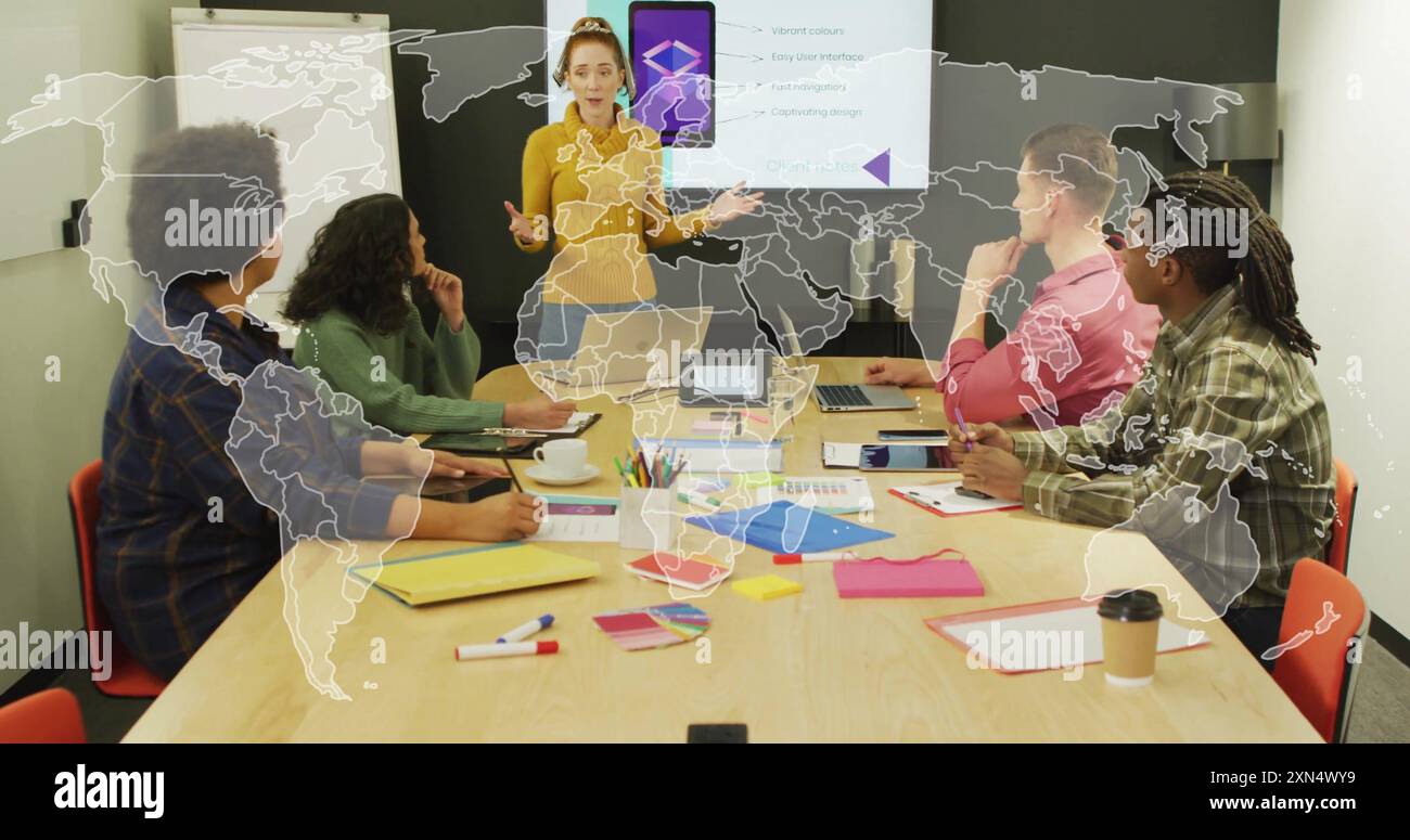 World map image over diverse team having meeting in conference room ...