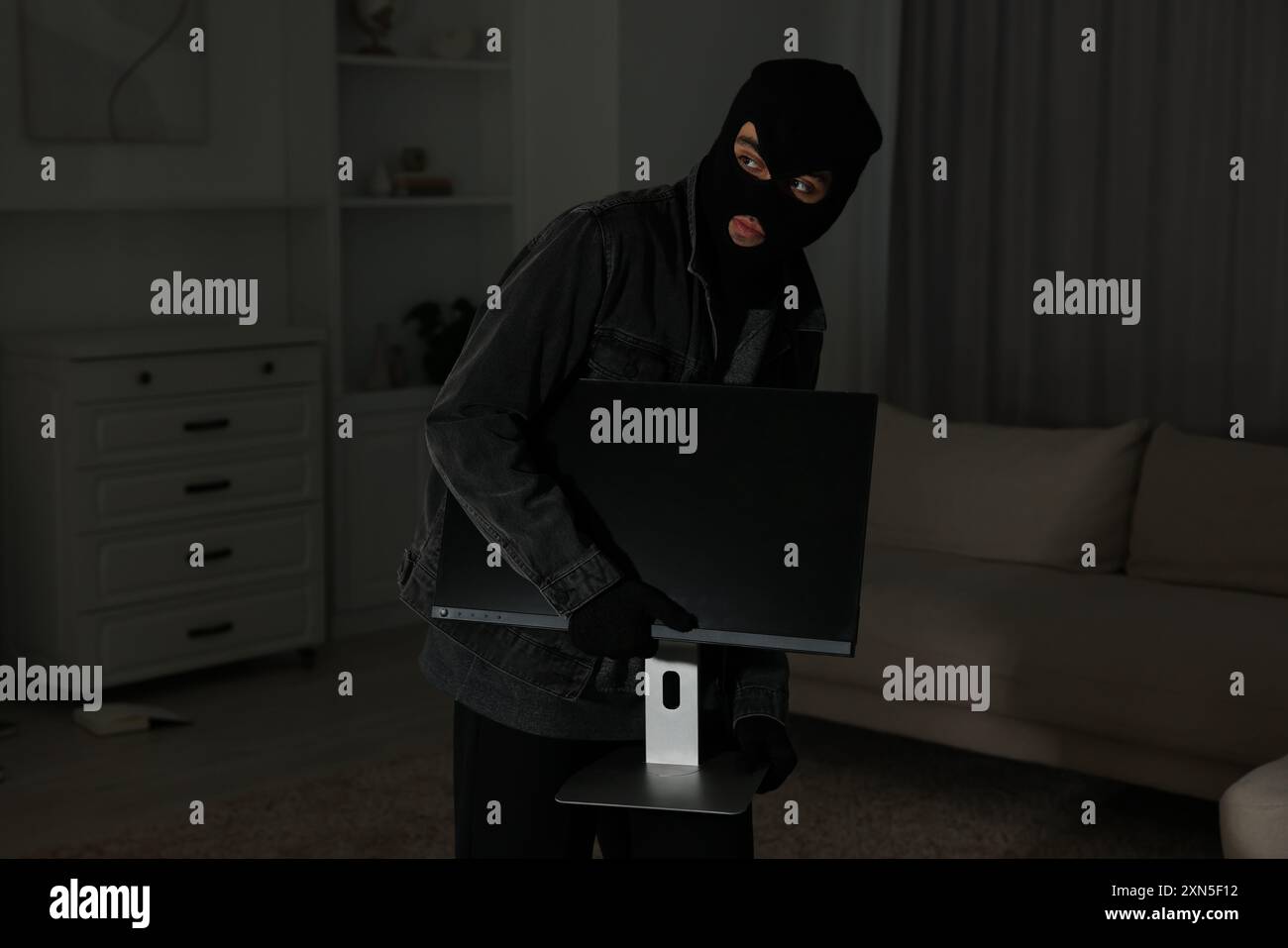 Thief stealing computer monitor at foreign house. Burglary Stock Photo ...