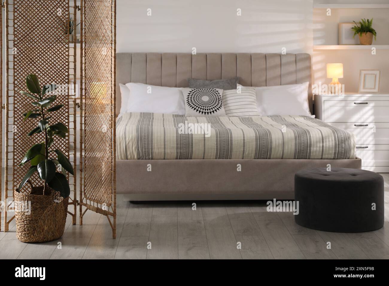 Folding screen and comfortable bed in bedroom. Interior design Stock ...