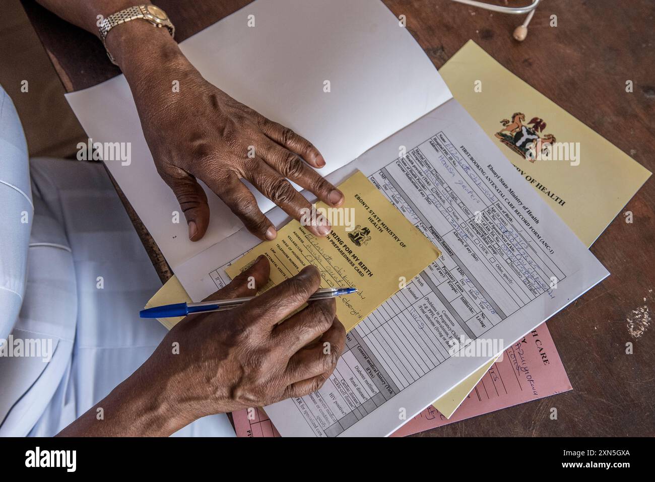 Nurse filling out healthcare forms for a pregnant woman. Photographed ...