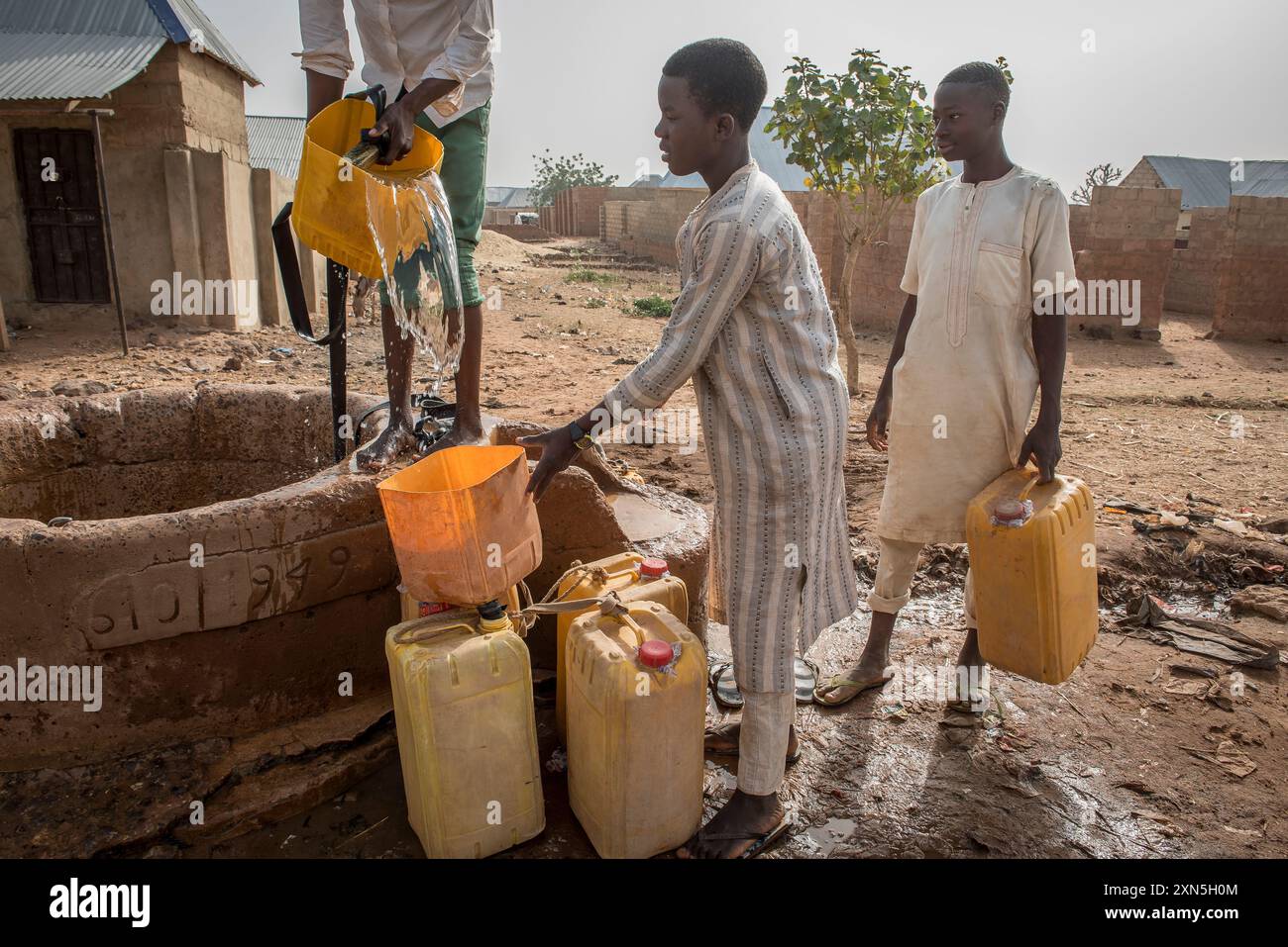 Boys collecting clean water from a well. Photographed in the Gagi ...