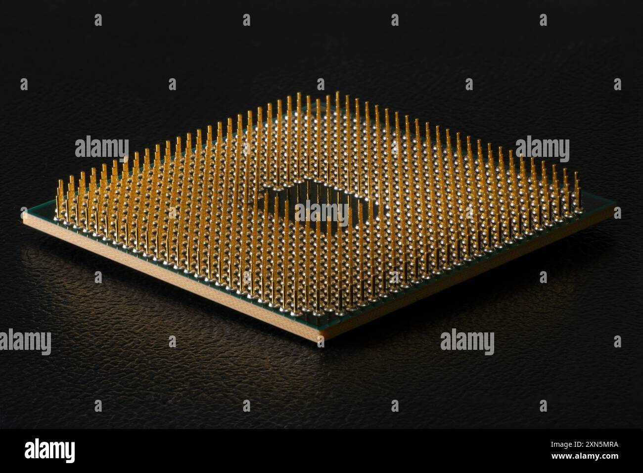 Low angle view of CPU processor chip pin side up isolated on black ...