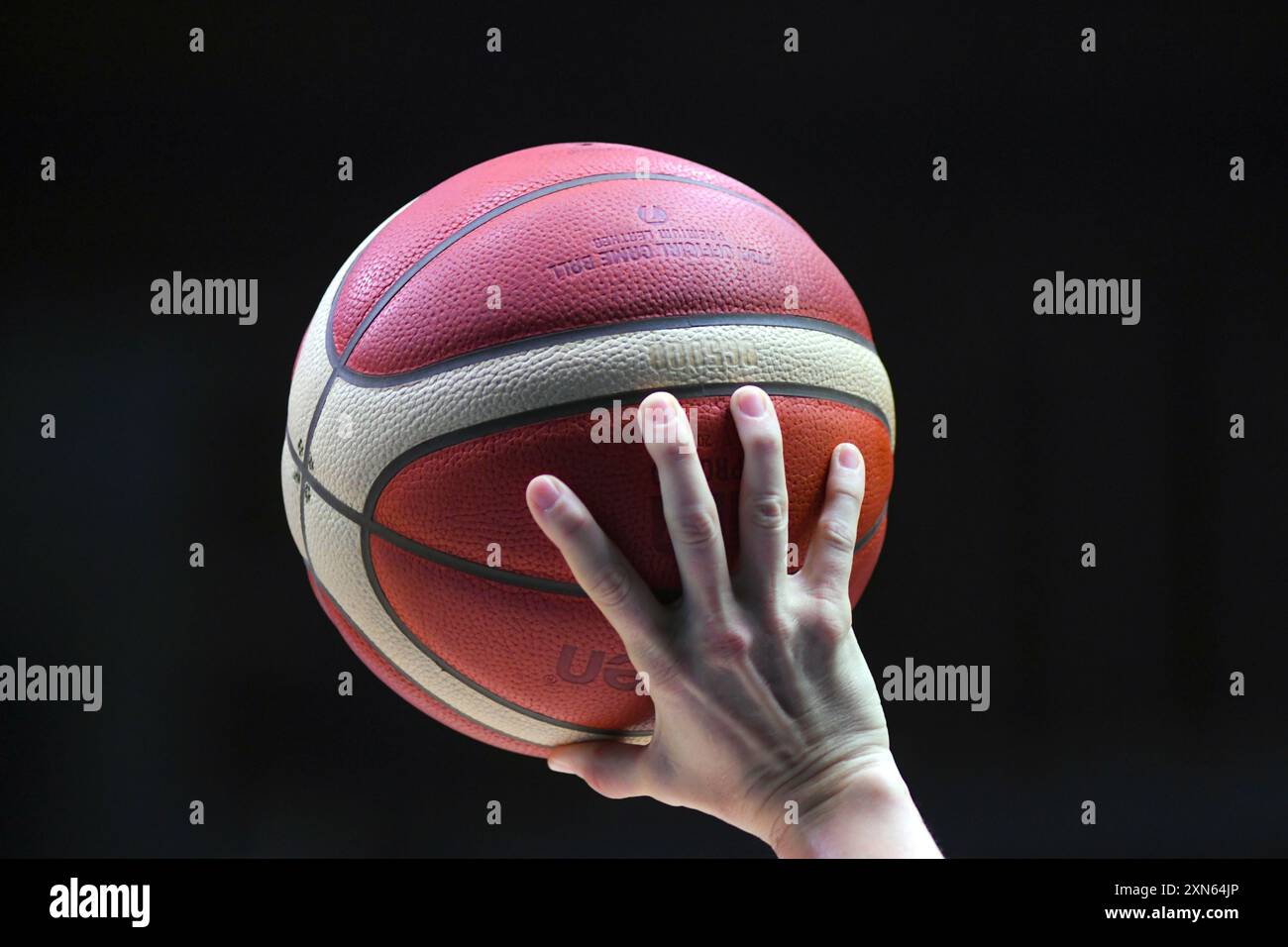 Referee Amy Bonner (USA) holding a basketball ball with his hand. FIBA ...