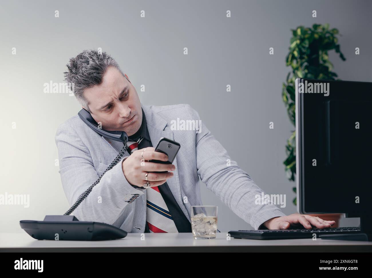 Businessman is struggling to keep up with his workload, looking ...