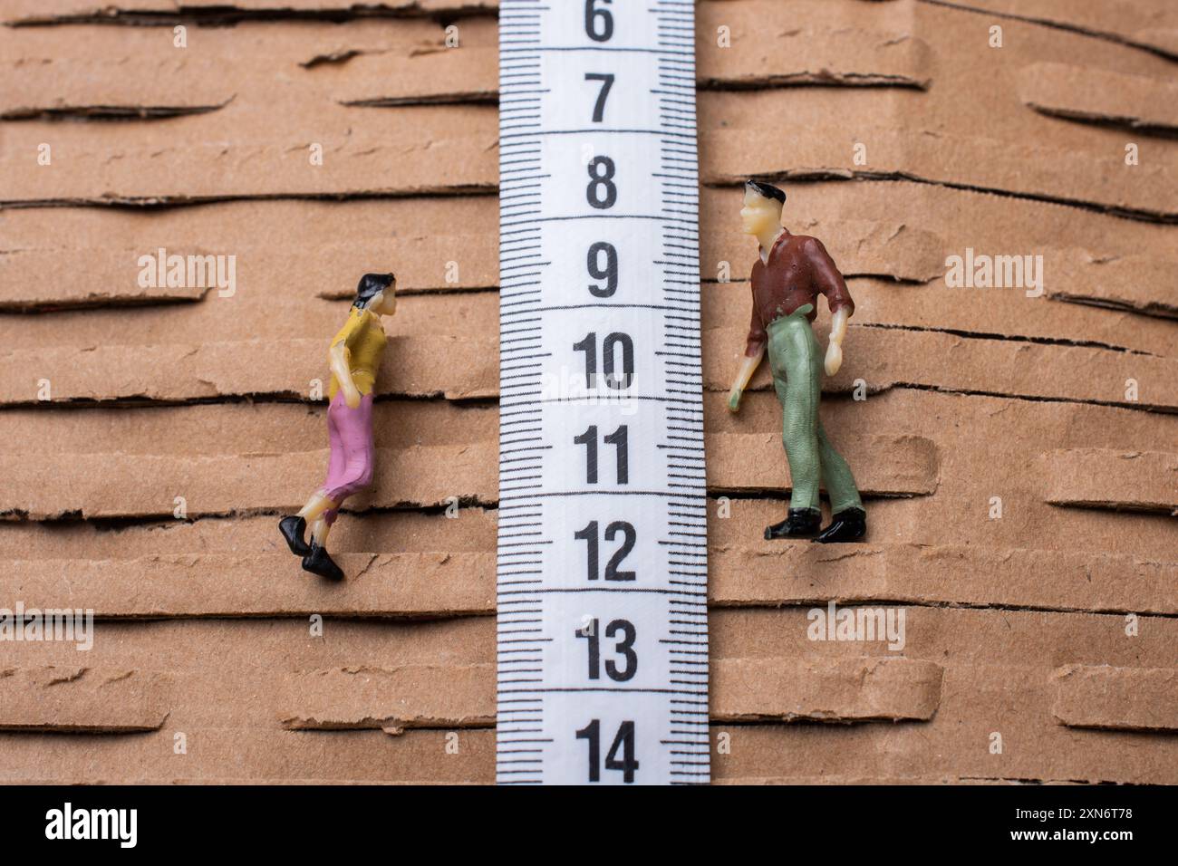 Man and Woman figurine and soft measuring tape. tape measure with ...