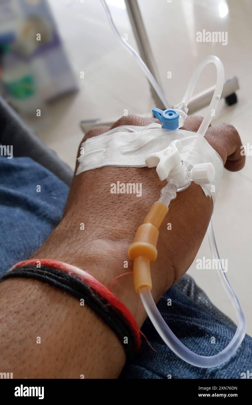 Male patient receiving infusion therapy in hospital, inserting venous ...
