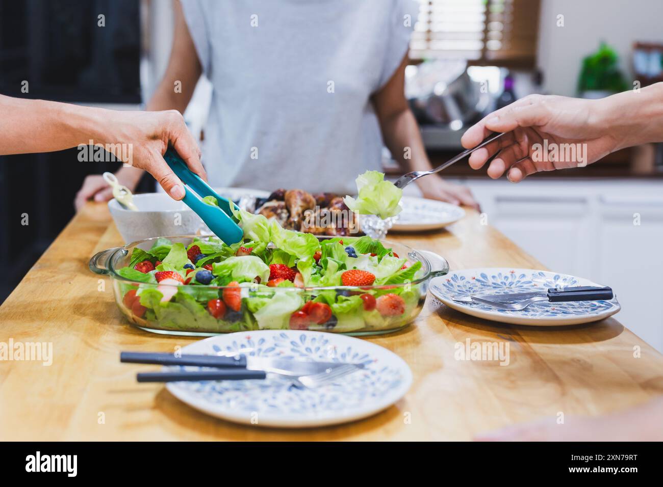 Group of friend eating fresh vegetable and fruit salad Stock Photo - Alamy