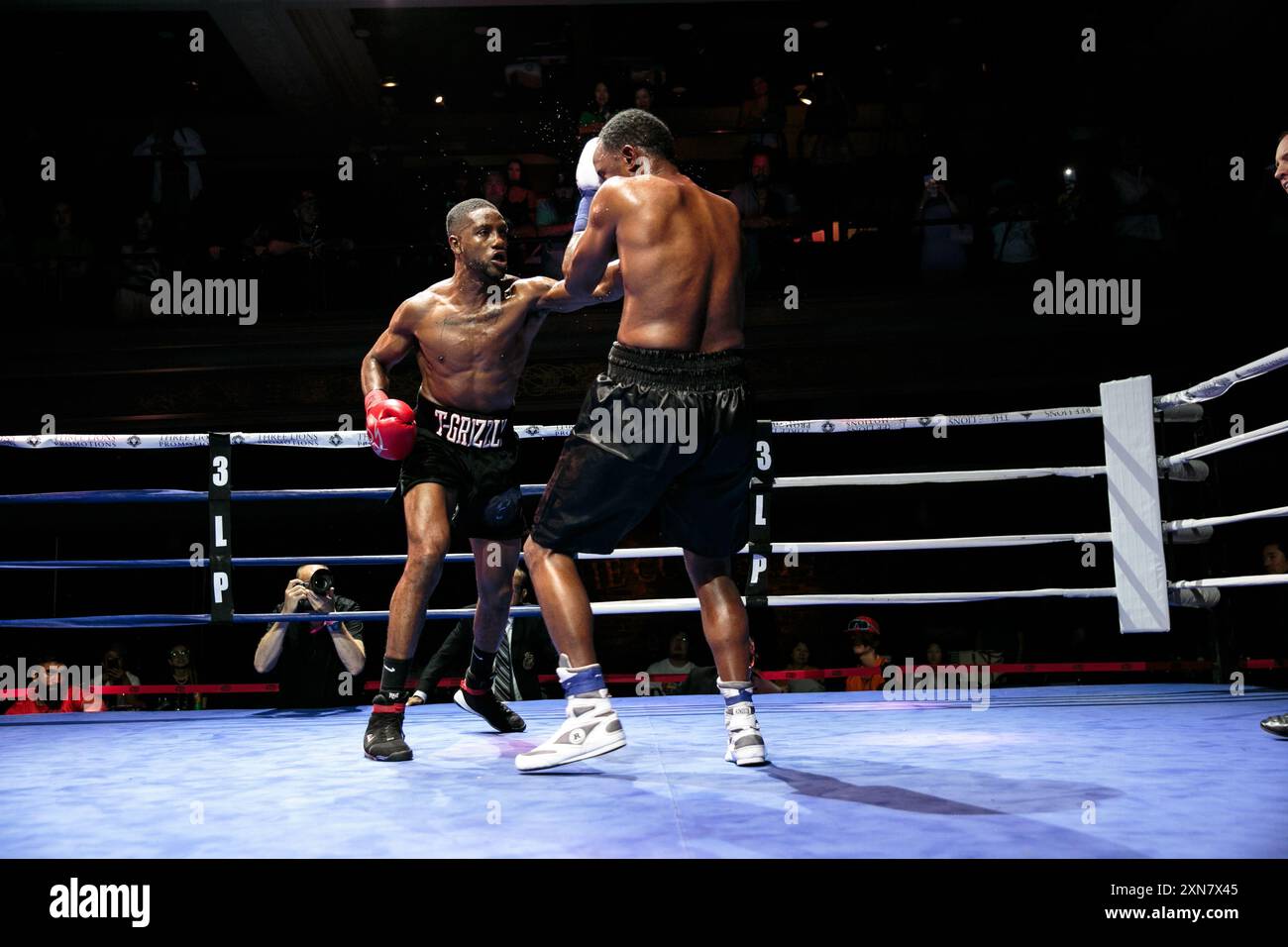 Tristan Brookes (red gloves) faces Mikhail Miller during a boxing match ...