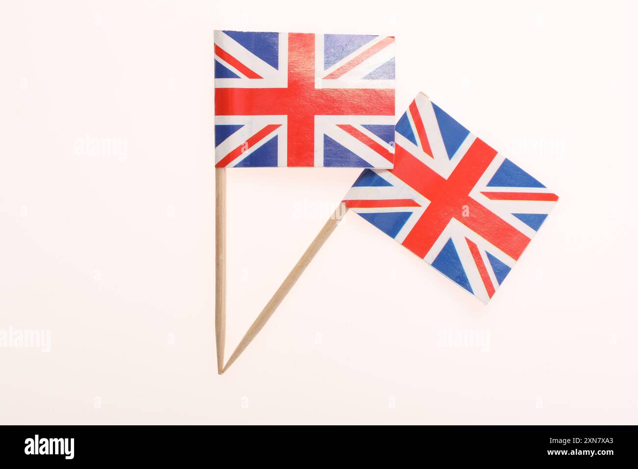 Small paper flags of United Kingdom isolated on white Stock Photo - Alamy