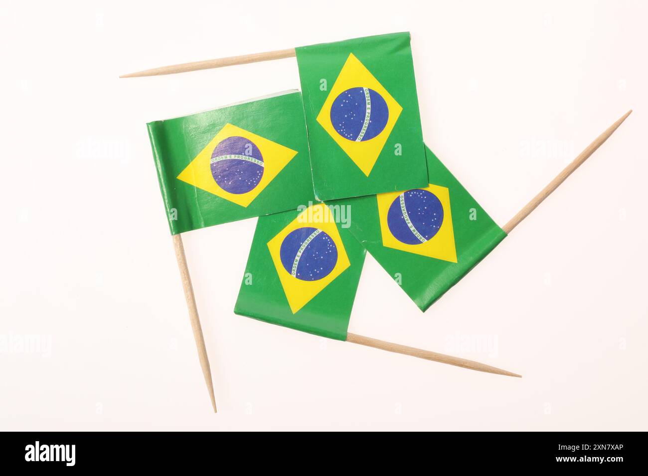 Small paper flags of Brazil isolated on white Stock Photo - Alamy