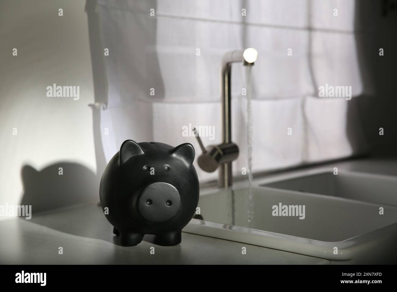 Water saving concept. Piggy bank and stream of water flowing from tap ...