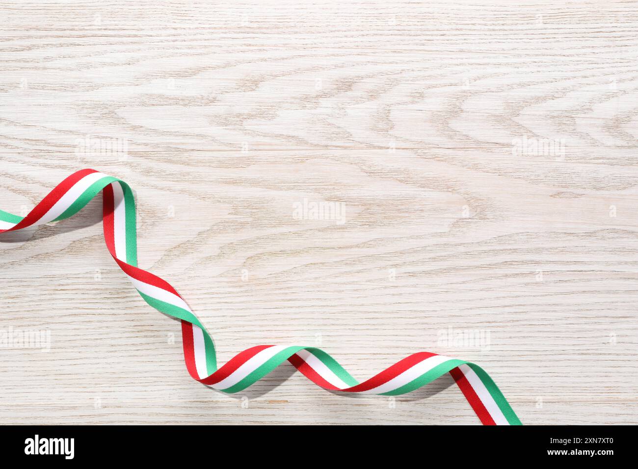 Ribbon in colors of Hungarian flag on white wooden background, top view ...