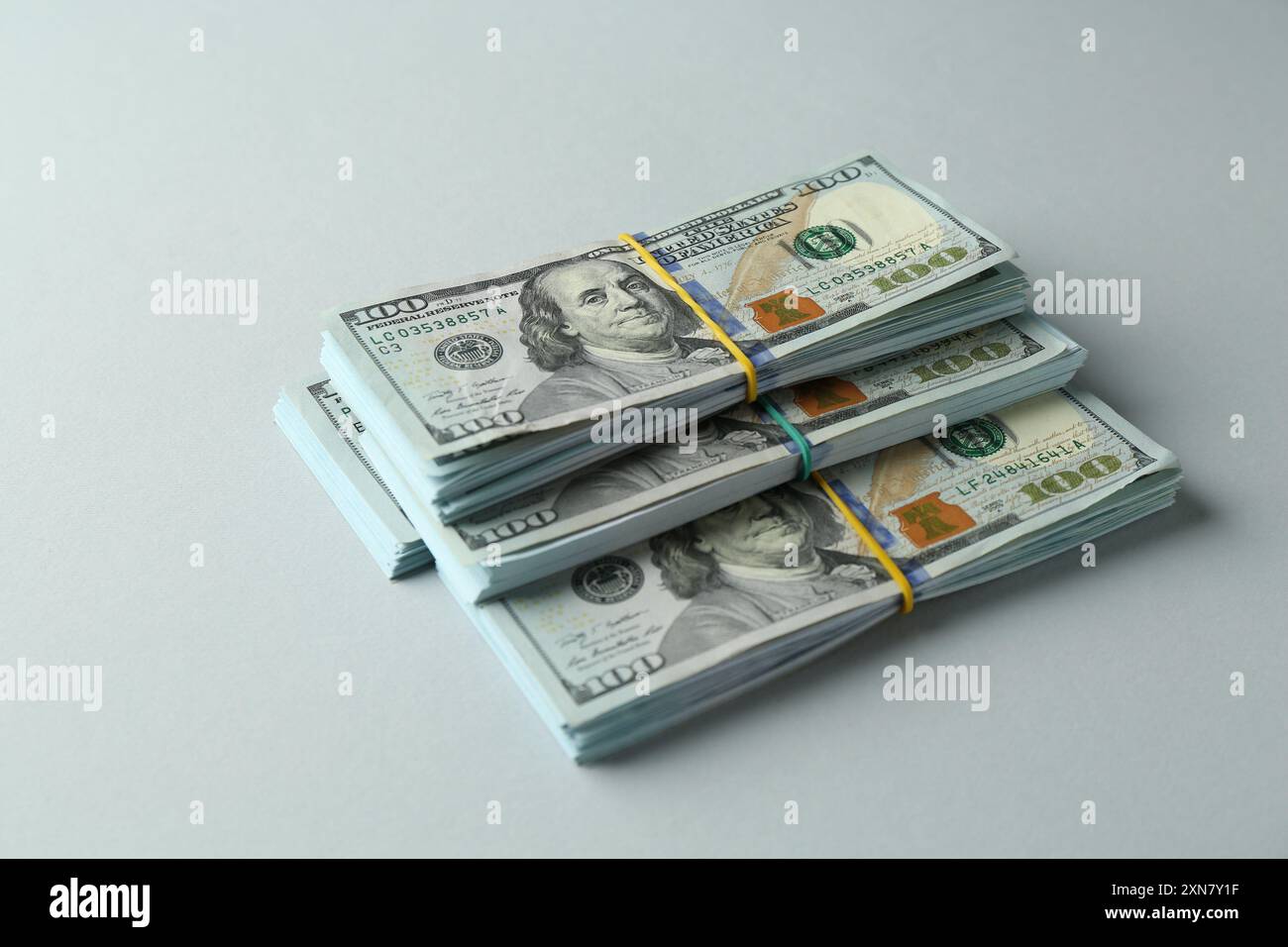 Bundles of dollar banknotes on light grey background Stock Photo - Alamy
