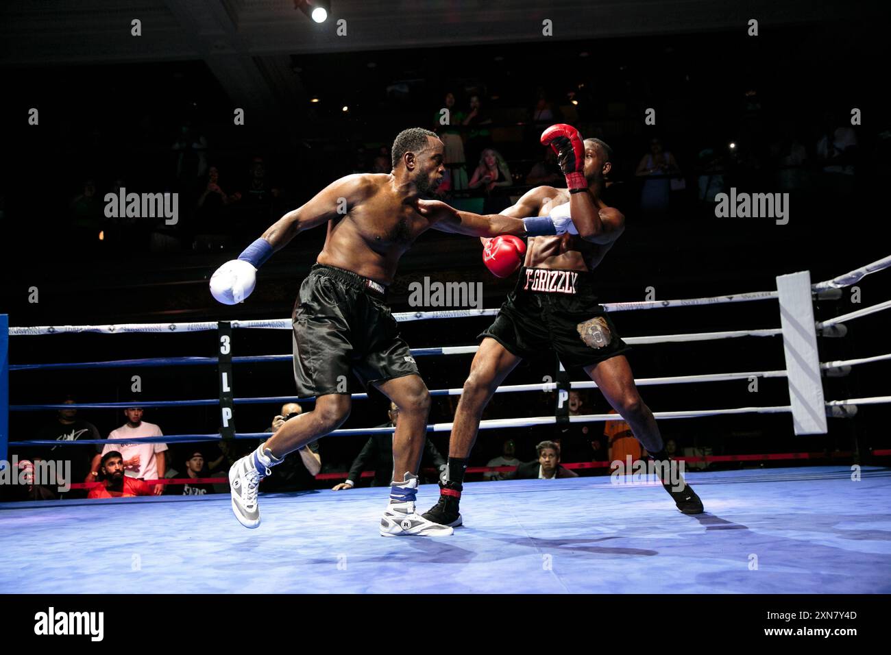 Tristan Brookes (red gloves) faces Mikhail Miller during a boxing match ...