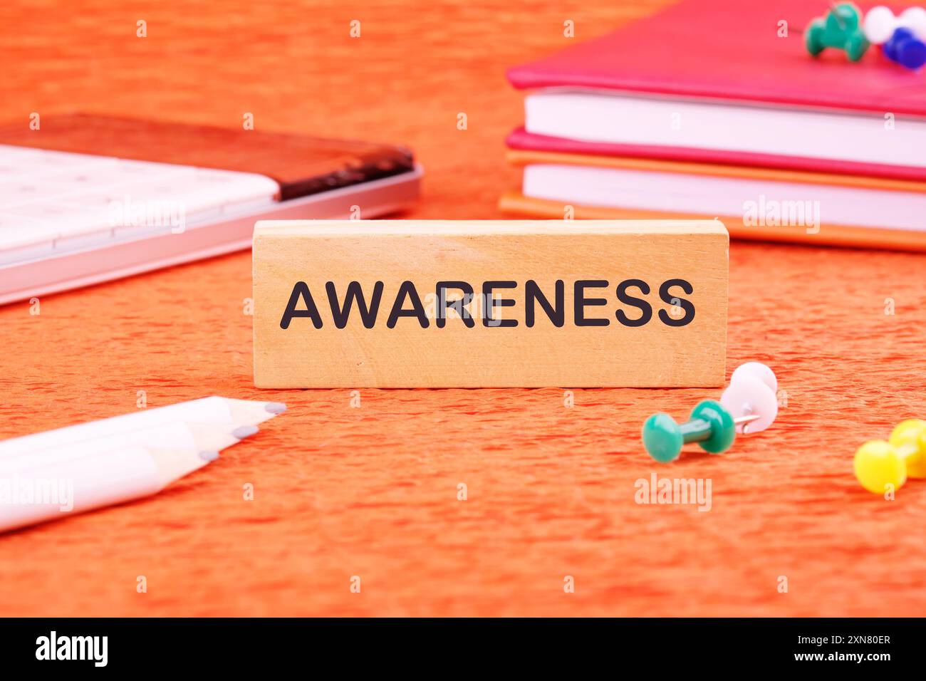 High or low awareness symbol. Concept word AWARENESS on wooden blocks ...