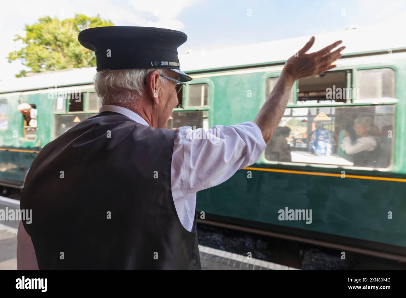 Platform guard waving goodbye to passengers hi-res stock photography ...