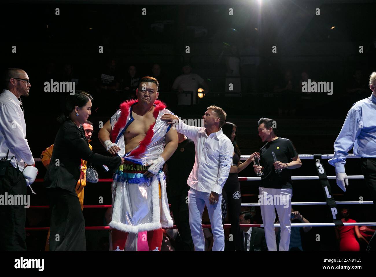 Junlong "The Dragon King" Zhang, in red and white gloves, celebrates a ...