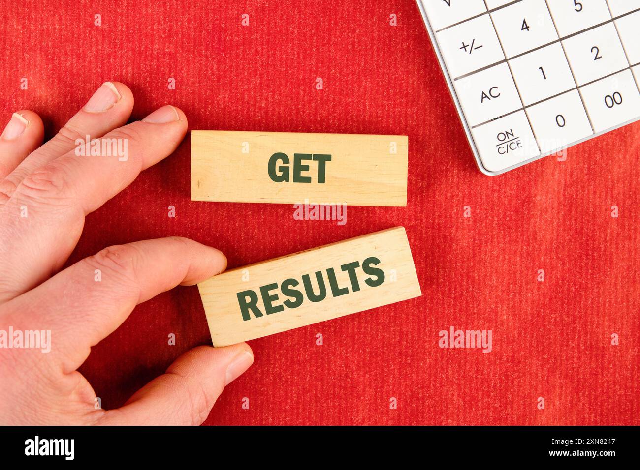 GET RESULTS text written lettering on wooden blocks on a red background ...