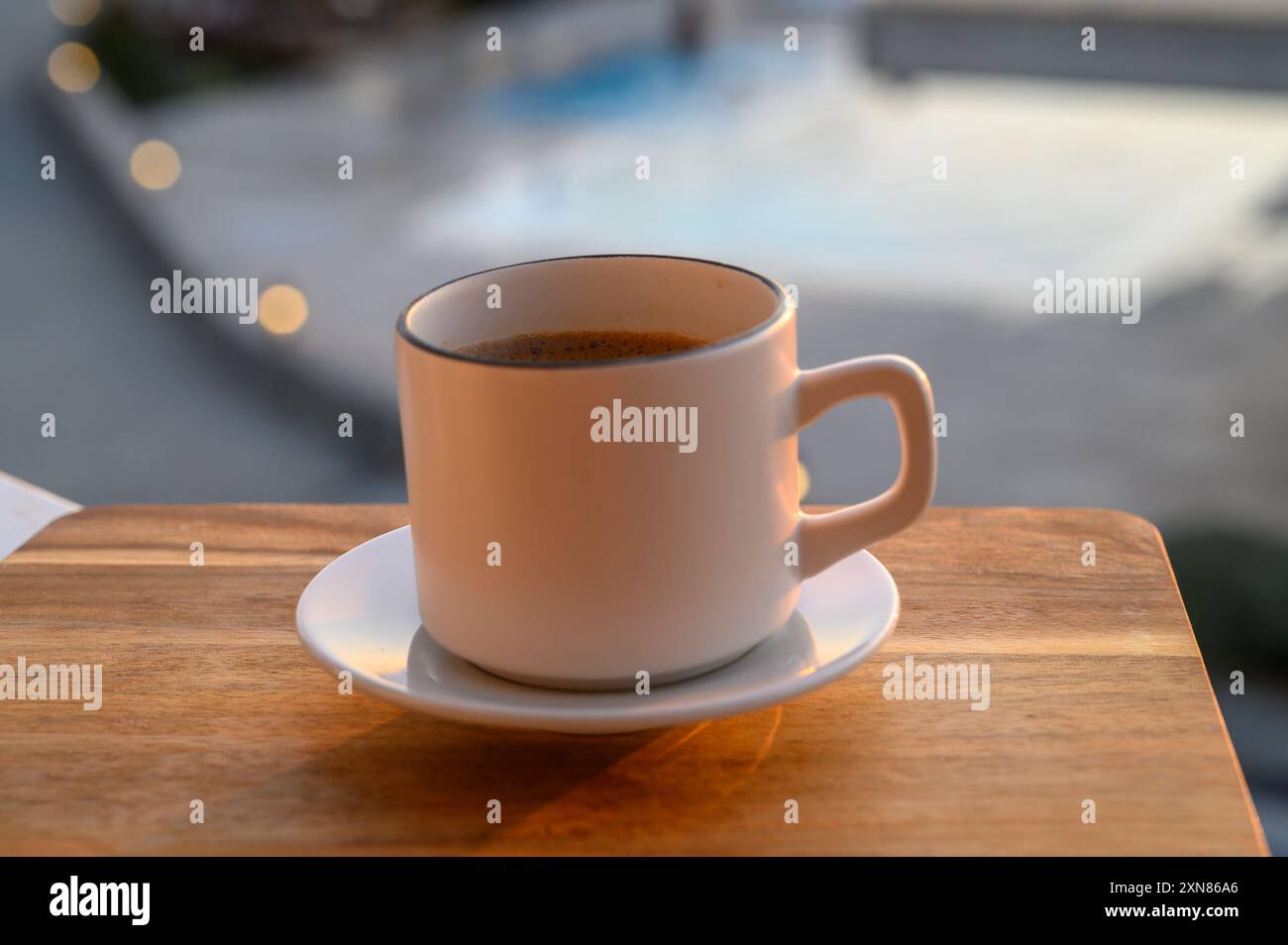 Black coffee in a mug on the background of the pool Stock Photo - Alamy
