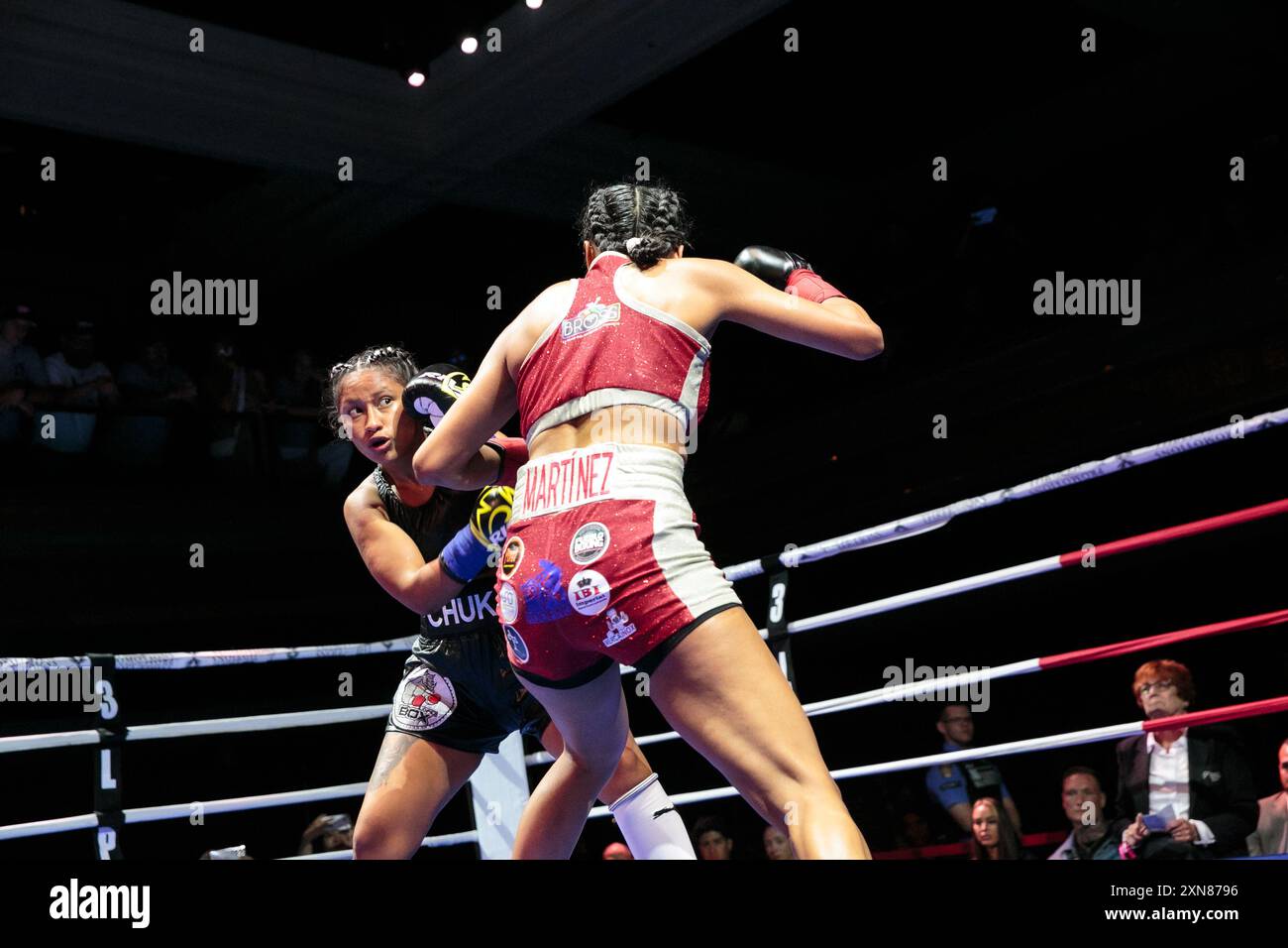 Meilyn Martinez (red trunks) and Shadem Aguilar face off during a ...