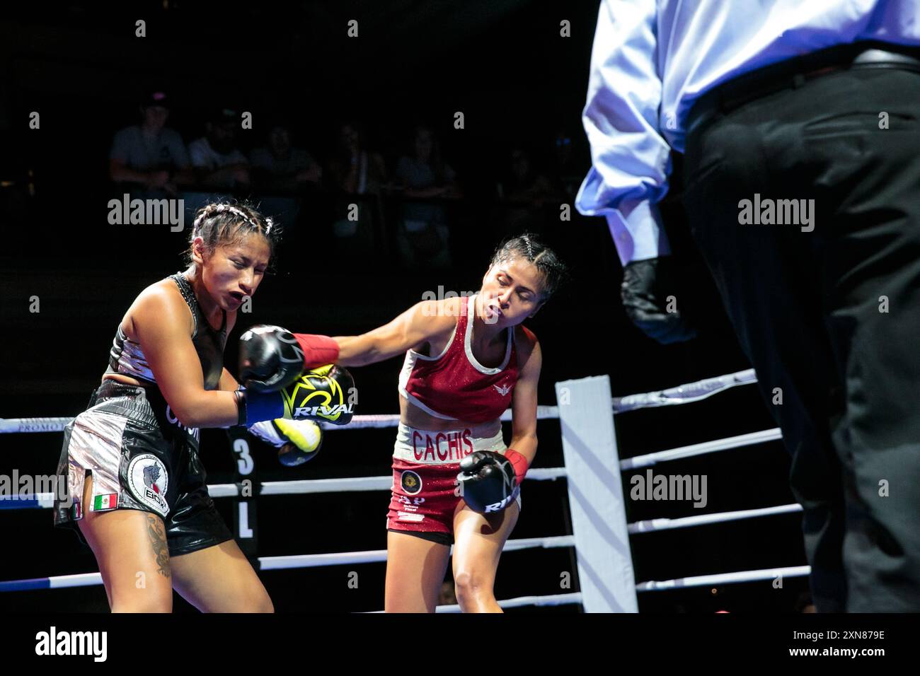 Meilyn Martinez (red trunks) and Shadem Aguilar face off during a ...