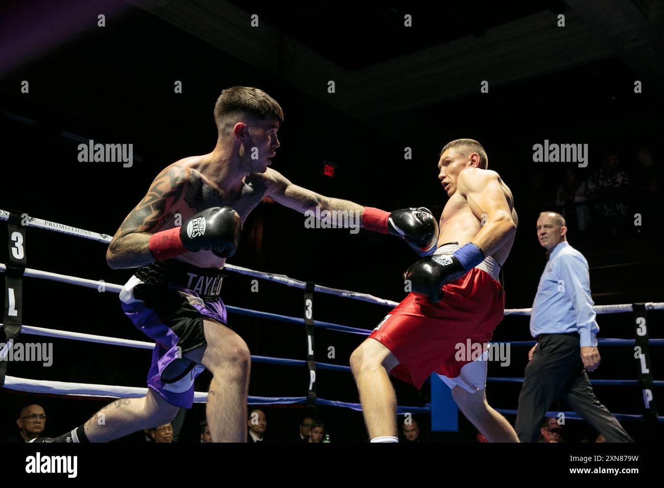 Dylan Taylor (purple trunks) faces Vitalii Maksymiv (red trunks) during ...