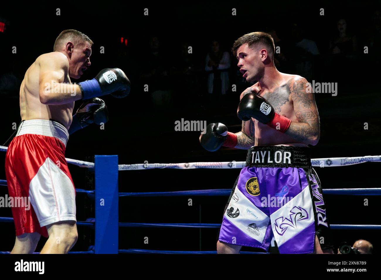 Dylan Taylor (purple trunks) faces Vitalii Maksymiv (red trunks) during ...