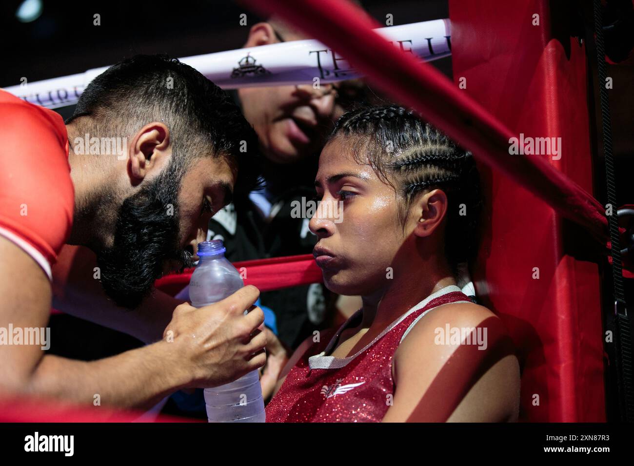 Meilyn Martinez is attended by her corner team during a boxing match at ...