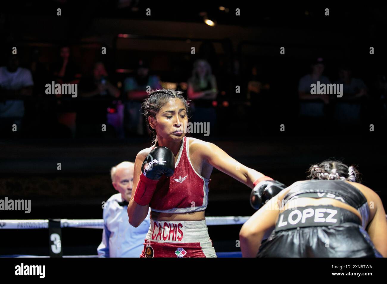 Meilyn Martinez (red trunks) and Shadem Aguilar face off during a ...