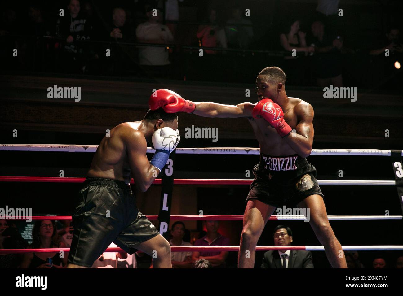 Tristan Brookes (red gloves) faces Mikhail Miller during a boxing match ...