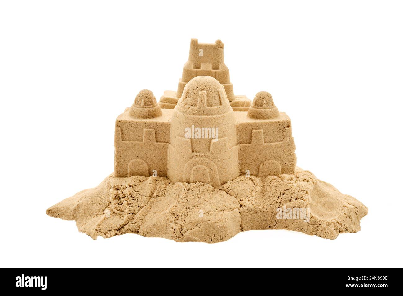 An intricate sandcastle with towers and detailed walls on a pile of ...