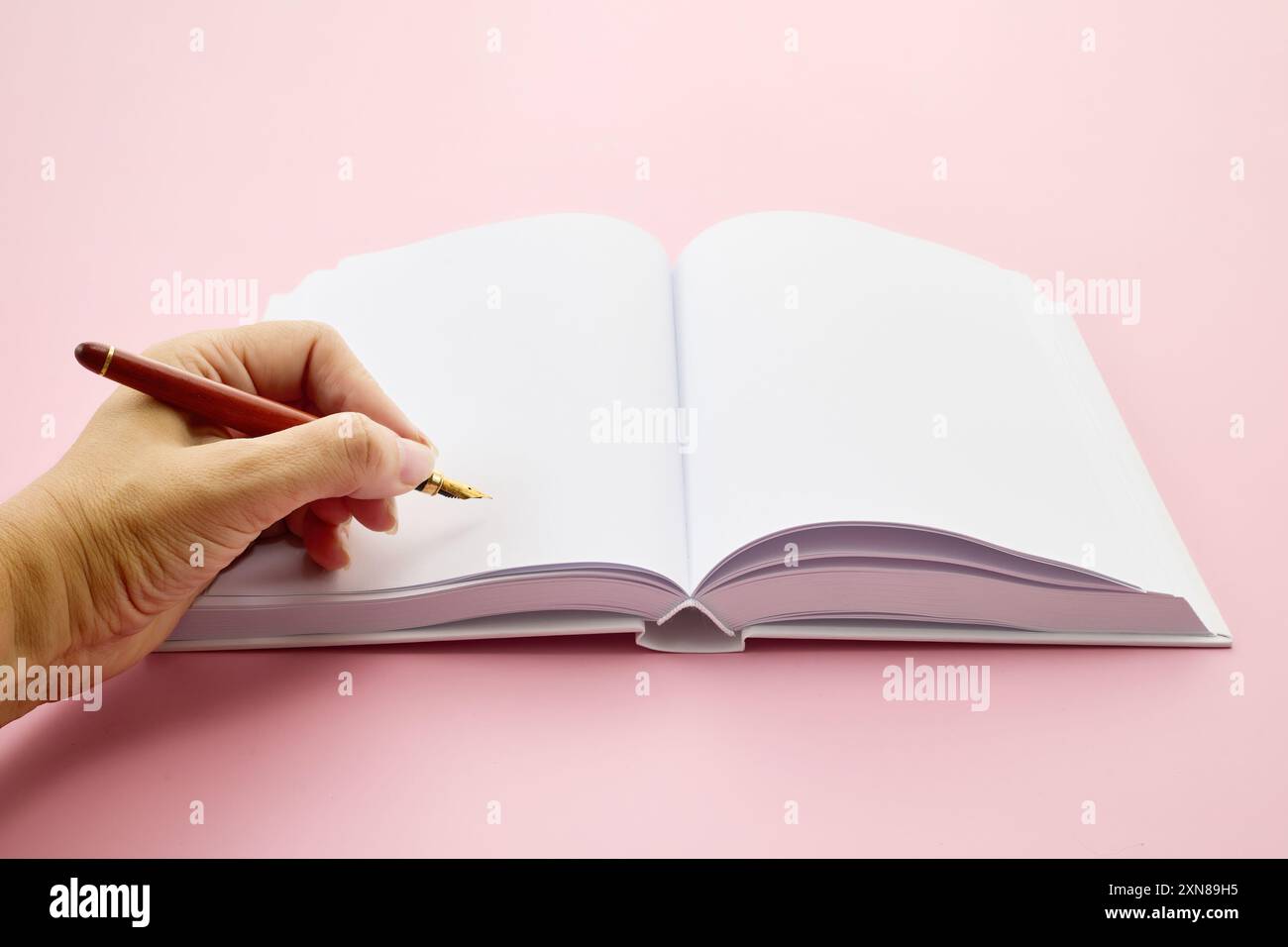 International Left-handers Day. Left Hand holding a pen, writing in an ...