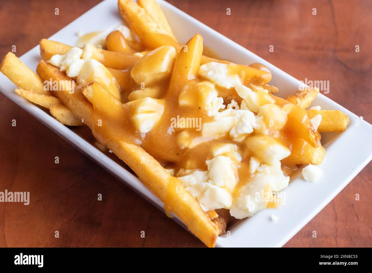 Poutine, a popular Canadian food of french fries with gravy and cheese ...
