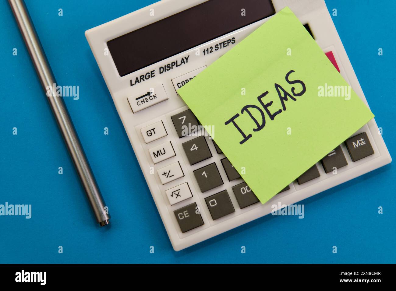 Green sticky note with "Ideas" written on a calculator. Concept for ...