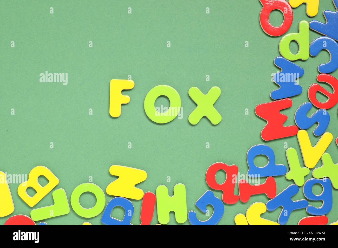 Word Fox made of magnetic letters on green background, flat lay ...