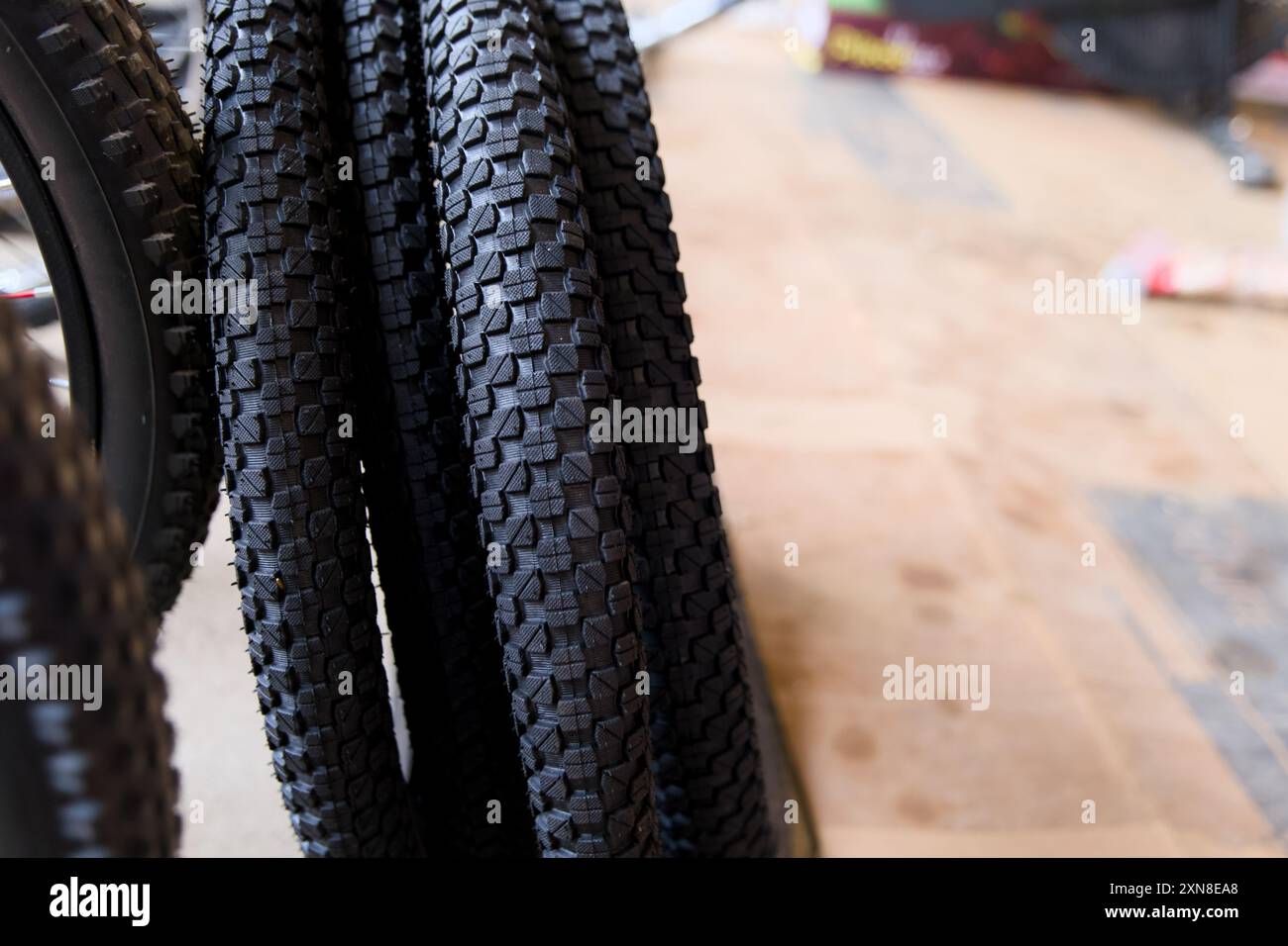 Rugged black bike tires lined up, close-up of tread pattern. Ready for ...
