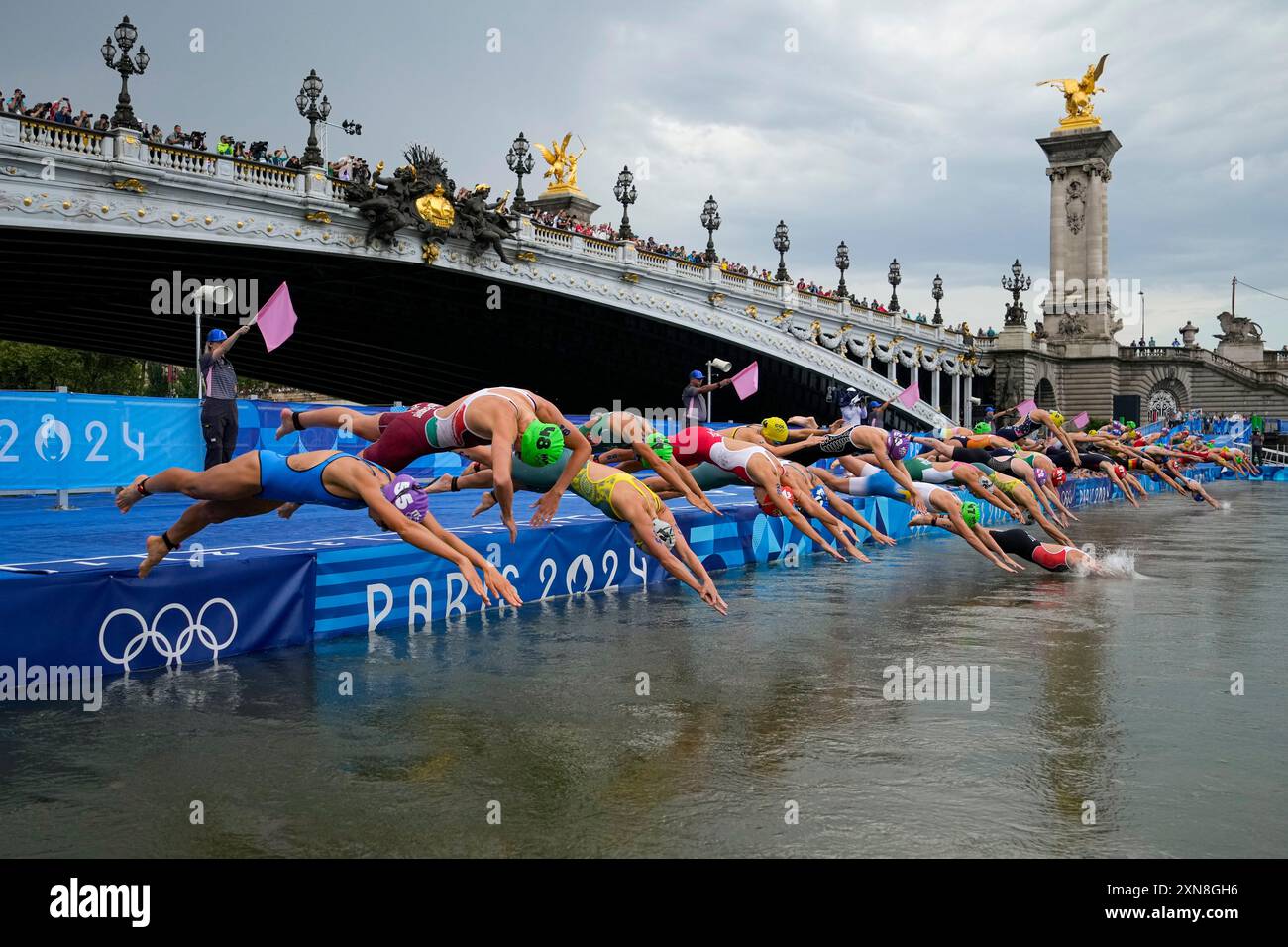 Athletes dive into the water for the start of the women's individual ...