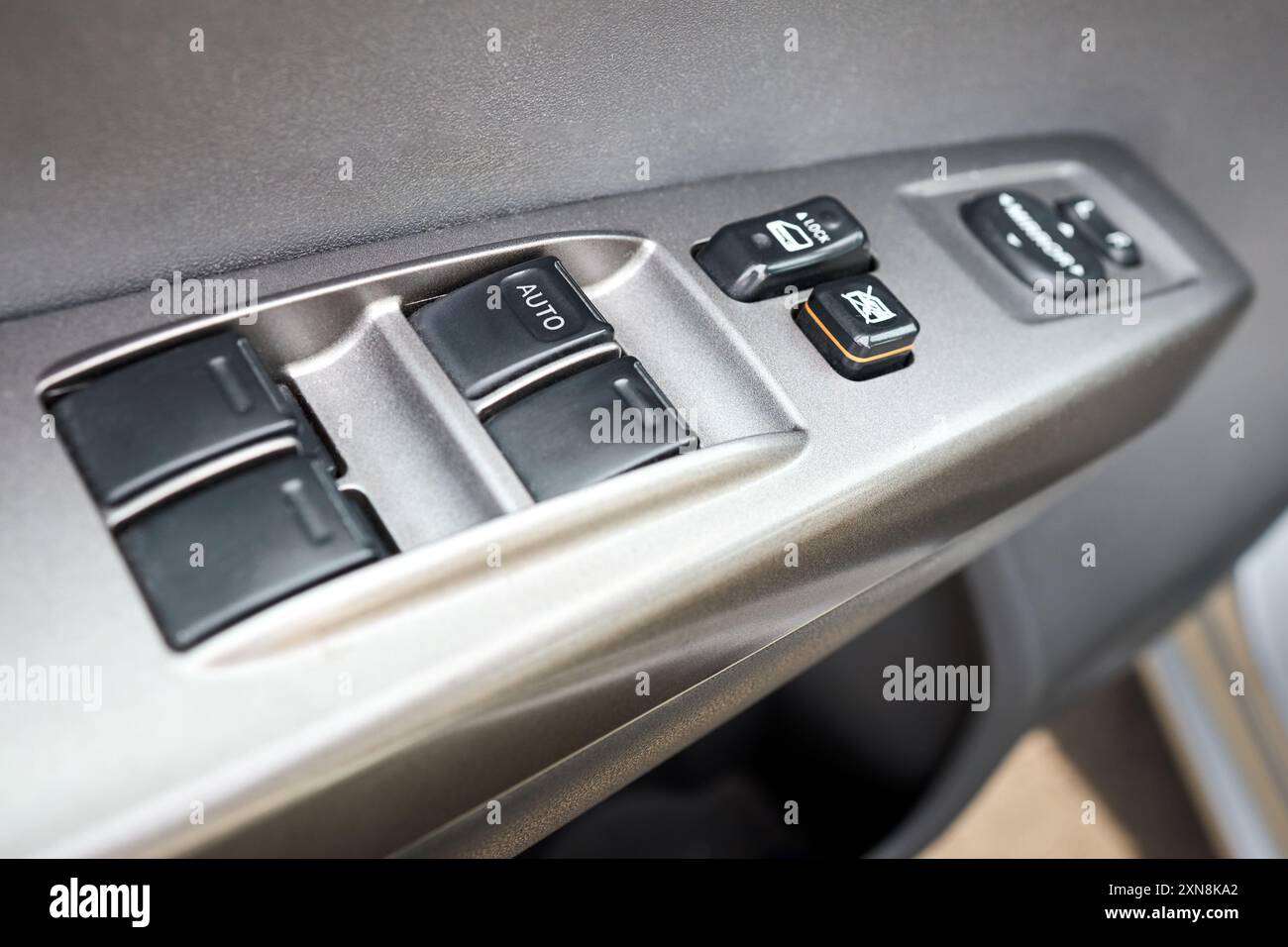 Modern hybrid electric car closeup interior detail. Driver door control ...