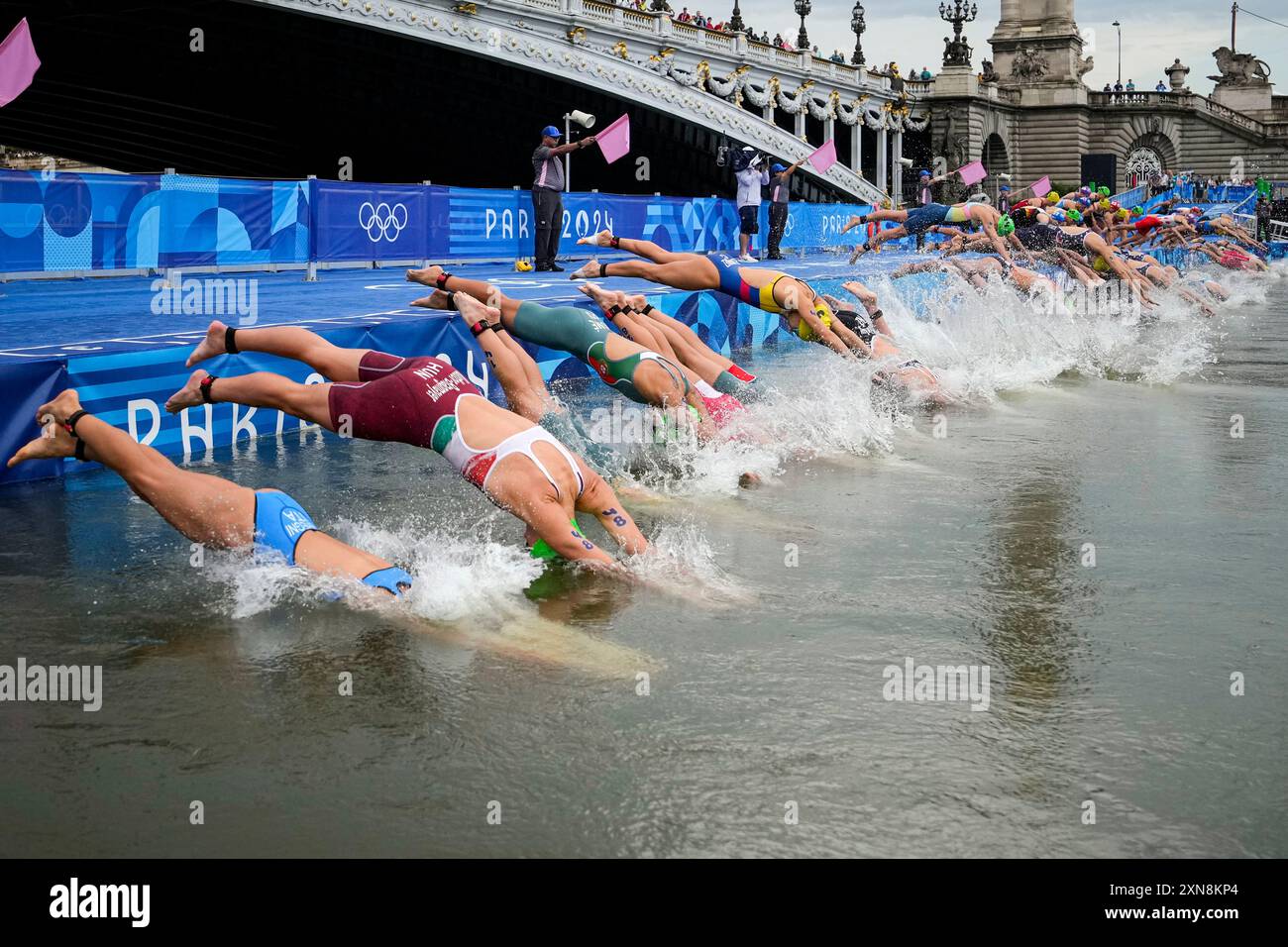 Athletes dive into the water for the start of the women's individual ...